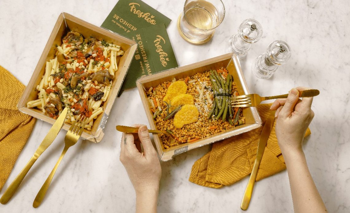 Man eating a box of meal